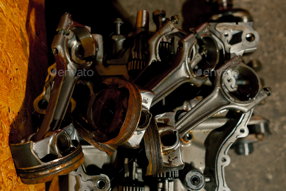 close up pistons and connecting rod on the table disassembled engine ...