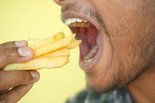hungry man eating fries closeup Stock Photo by towfiqu98 | PhotoDune