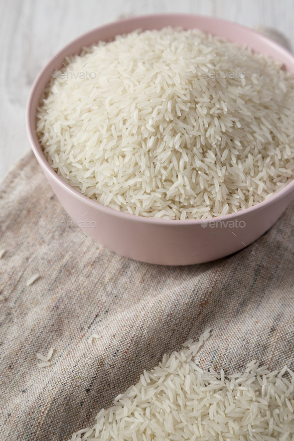 Dry white rice basmati in a pink bowl, side view. Closeup. Stock Photo ...