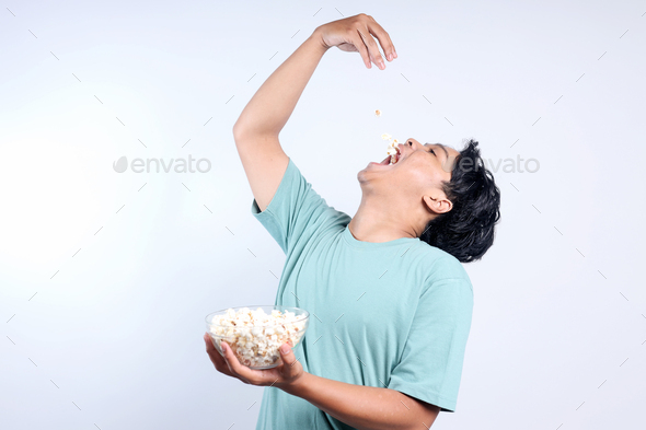 Funny Asian Man Eating Popcorn Stock Photo by Queenmoonlite35 | PhotoDune