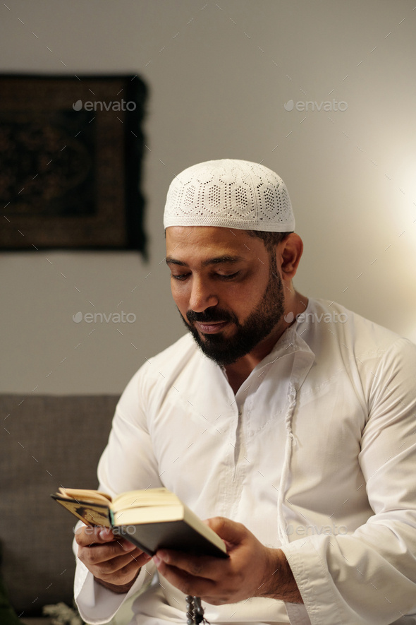 Modern Muslim Man Reading Quran Stock Photo by Pressmaster | PhotoDune
