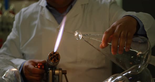 Front view of mature Indian male worker making wing glass in glass ...