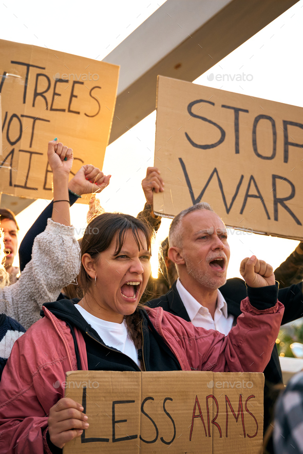 Multiracial diverse ages people protesting against war and violence in ...