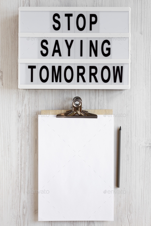 'Stop saying tomorrow' words on a modern board, clipboard with blank ...