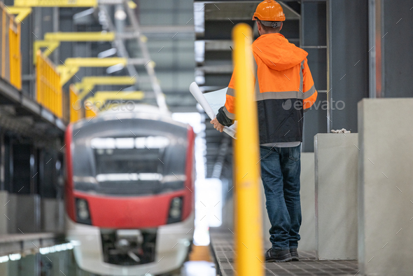 Engineer plan green railway project with infrastructure blueprint ...