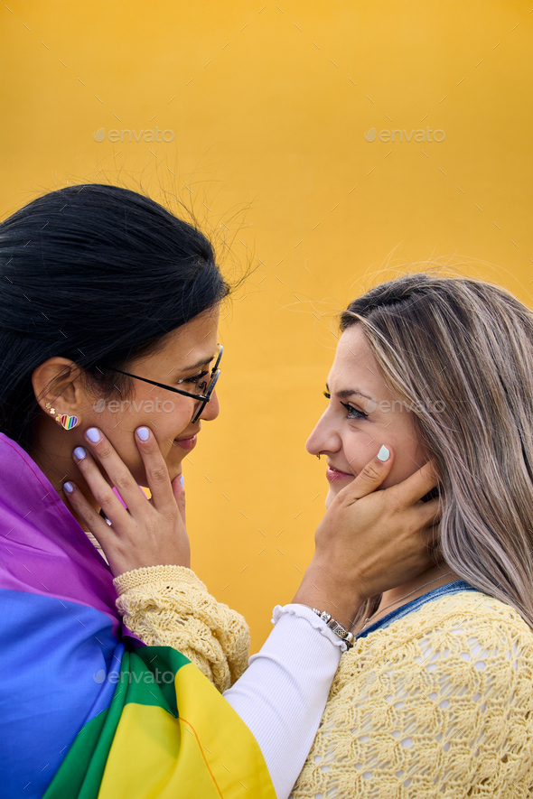 Real couple young women hugging and looking into each other eyes ...