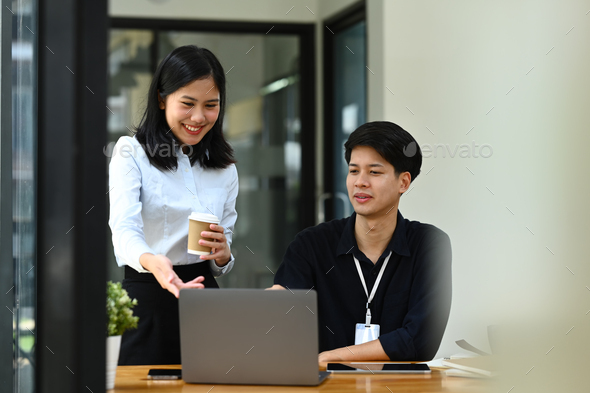 Friendly female manager explaining information, analyzing sales ...