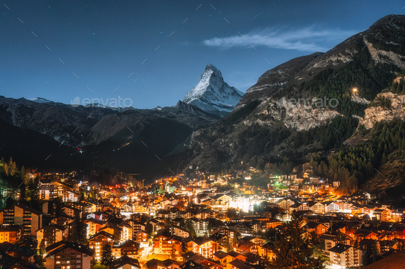 Zermatt village with light glowing and Matterhorn peak in the night at ...