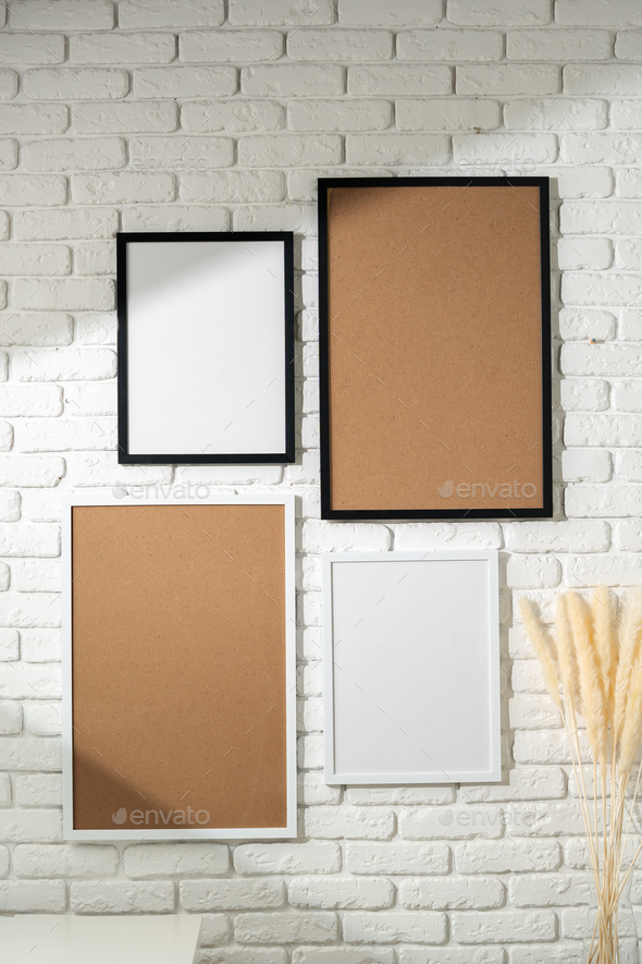 Varied Sized Photo Frames Displayed on a White Brick Wall Stock Photo ...