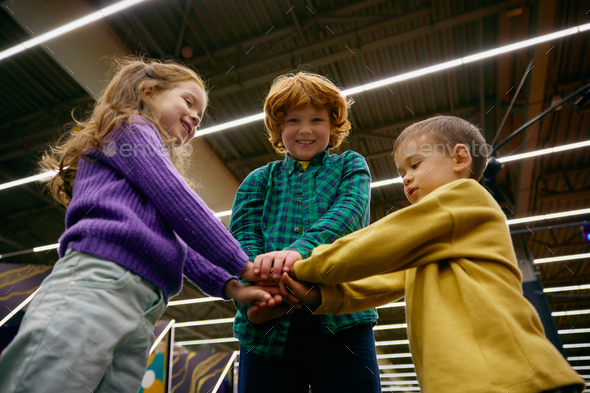 Children having fun in play area standing in circle Stock Photo by ...