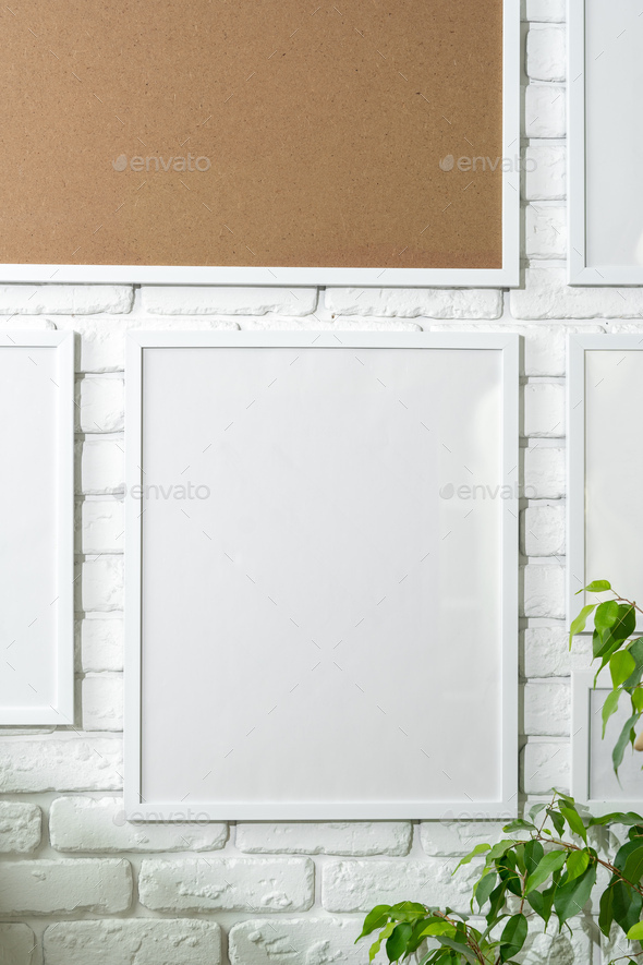 Varied Sized Photo Frames Displayed on a White Brick Wall Stock Photo ...