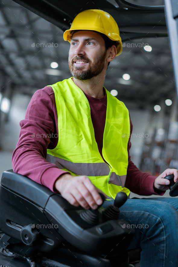 Smiling, handsome worker, professional driver wearing hard hat and ...