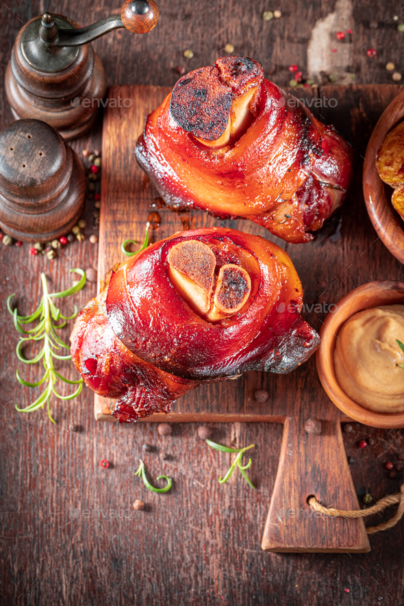 Hot roasted ham hock served with potatoes and pickled cabbage. Stock ...