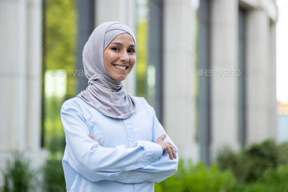 Confident Muslim woman standing outdoors with arms crossed Stock Photo ...