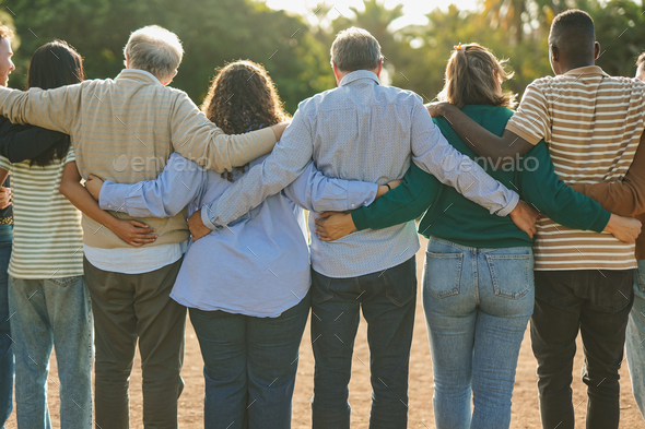 Group of multiracial people hugging each other at city park Stock Photo ...