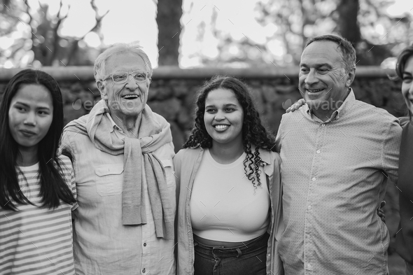 Group of multi generational people hugging each other outdoor Stock ...