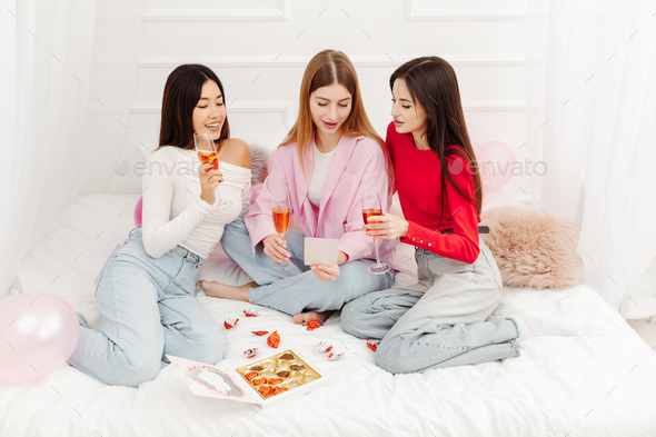 Group of smiling multiracial beautiful women drinking wine, eating ...