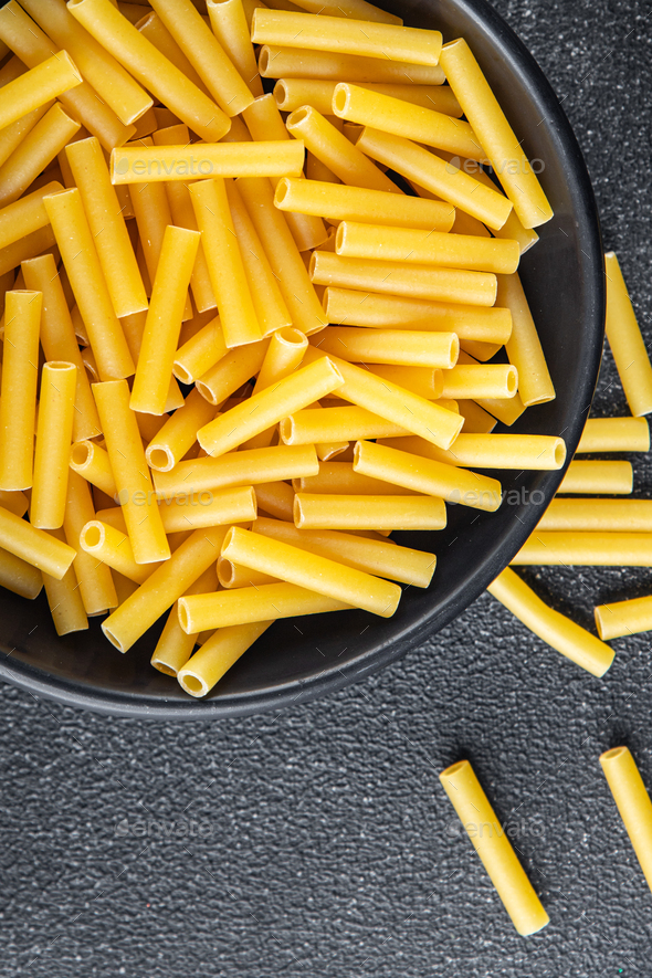 tortiglioni raw pasta cooking appetizer meal food snack on the table ...