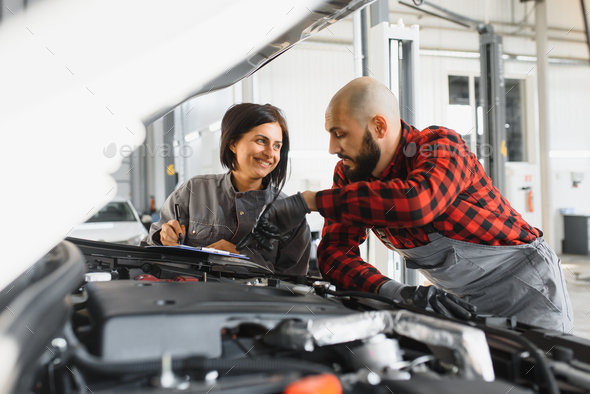 mechanic men with wrench repairing car engine at workshop Stock Photo ...
