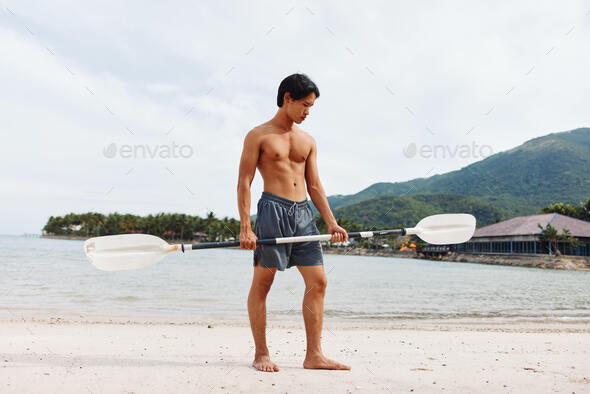 Active Asian Man Enjoying Sunset Surfing on Paddleboard in Summer Beach ...