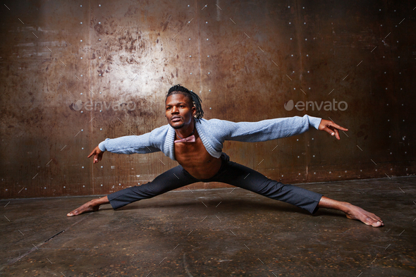 Attractive African American man showcases flexibility and balance ...