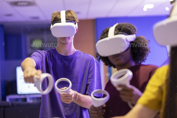 Teenagers Engrossed in Immersive Virtual Reality Gaming Stock Photo by ...