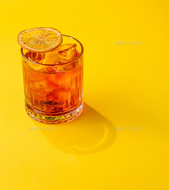 Cocktail Negroni on yellow background Stock Photo by AntAlexStudio