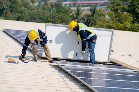workers installing solar panels, for efficient energy on rooftop Stock ...