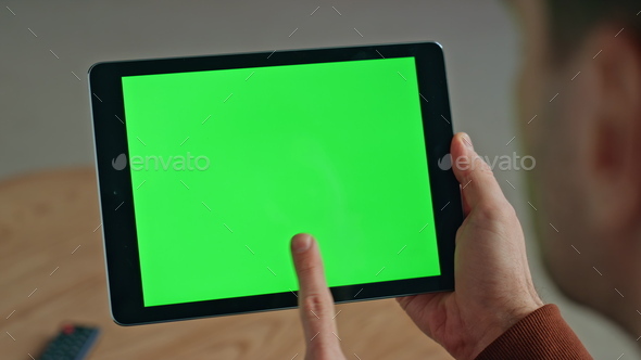 Man hand touching green tablet screen closeup. Manager holding mockup ...