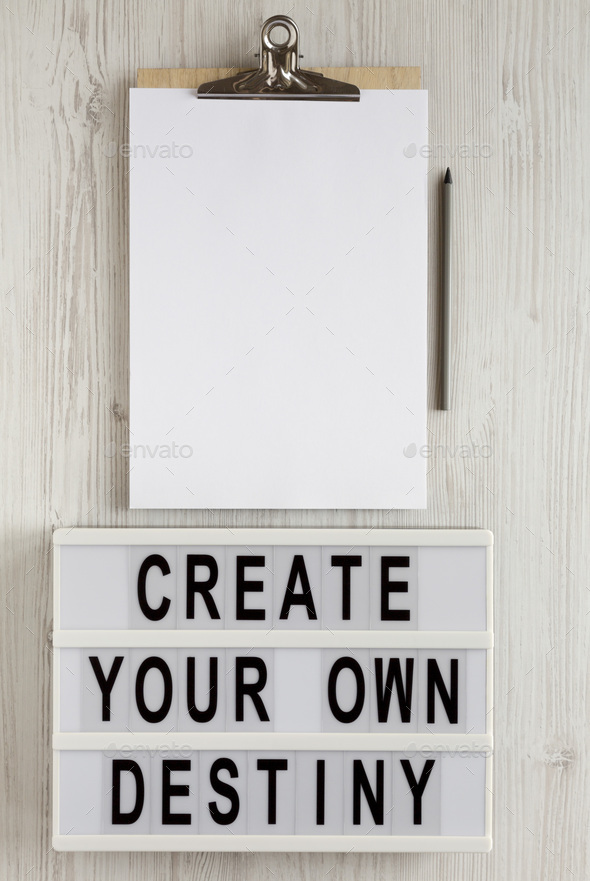 'Create your own destiny' words on a modern board, clipboard with blank ...