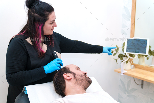 Patient Receives Detailed Scalp Analysis for Hair Treatment Stock Photo ...