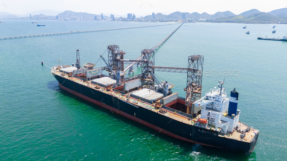 Aerial top view wood chips load chip from silo to cargo ship vessel ...