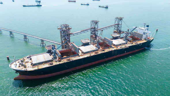 Aerial top view wood chips load chip from silo to cargo ship vessel ...