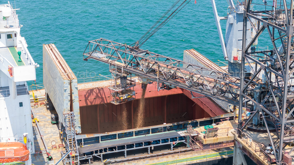 Aerial top view wood chips load chip from silo to cargo ship vessel ...