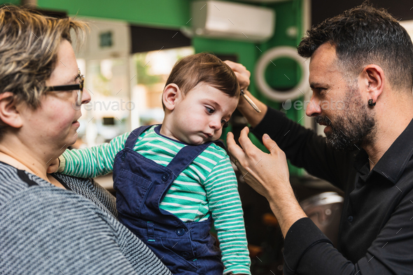 Toddler's first haircut at barber shop Stock Photo by jorditudela ...
