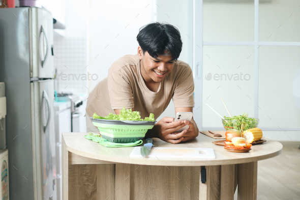Young Man Watching Tutorial Making Salad Stock Photo by Queenmoonlite35