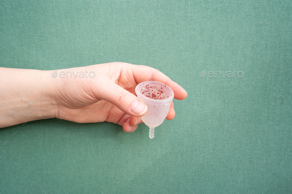 Menstrual cap over violet background Stock Photo by Neirfy007 | PhotoDune