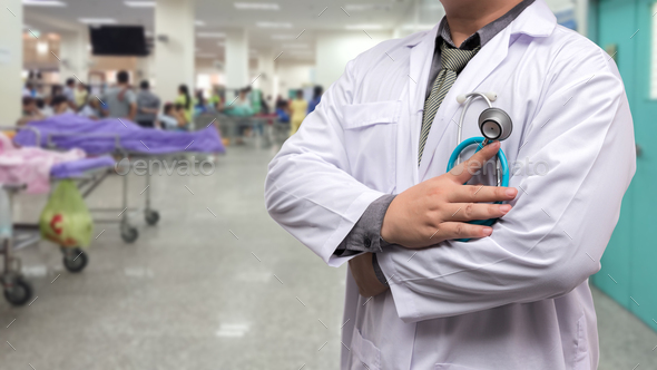 Doctor in gown uniform with stethoscope standing and fold his arms over ...