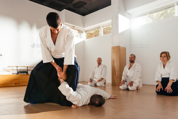 Martial Arts Sensei Demonstrating Wrist Lock Technique to Students in ...