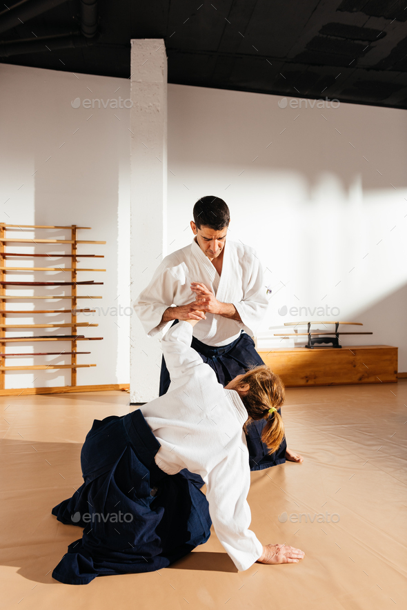 Martial Arts Sensei Demonstrating Wrist Lock Technique to Female ...