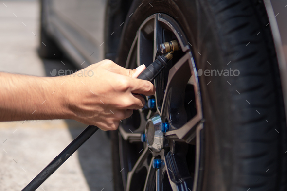 Closeup image of man inflating tire. Stock Photo by mohdizzuanbinroslan