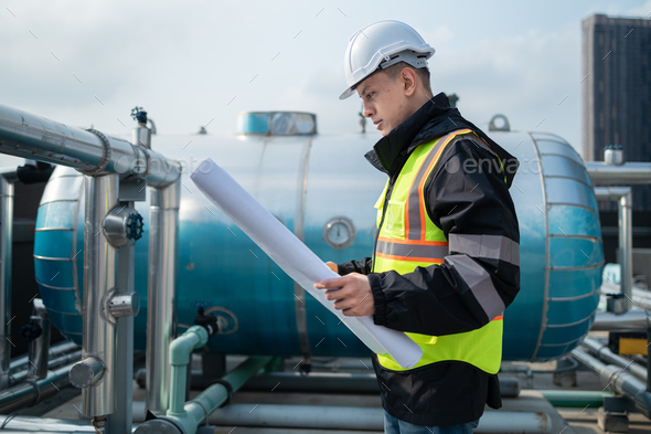 Engineer Analyzing Blueprints at Industrial Pipeline Site Stock Photo ...