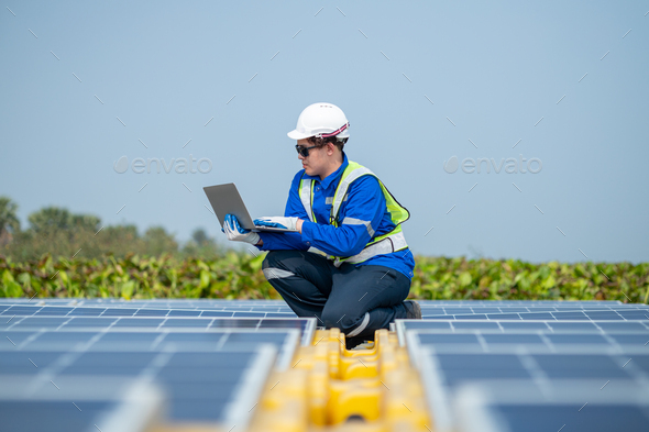 Solar Technician Monitoring Panels with Laptop Stock Photo by PICCOLINO208
