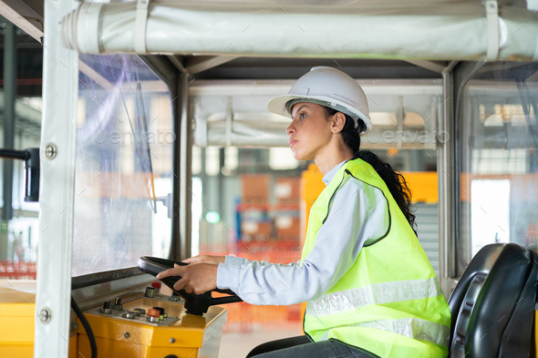 Warehouse Worker Operating Electric Tugger Stock Photo by PICCOLINO208