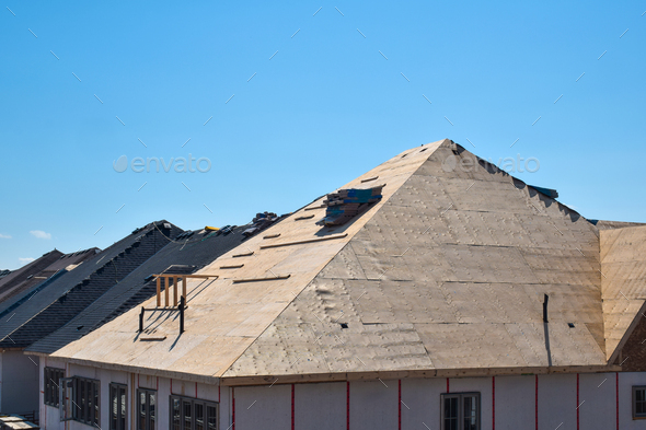 Plywood sheathing layer during roof building construction on new ...
