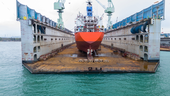 Oil tanker ship at dry dock concept maintenance service. working at dry ...