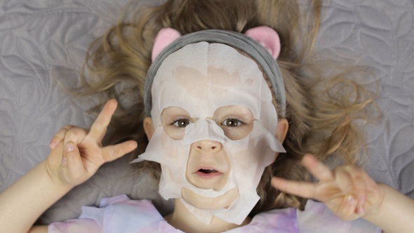 Teen Girl Applying Moisturizing Face Mask. Child Kid Take Care of Skin ...