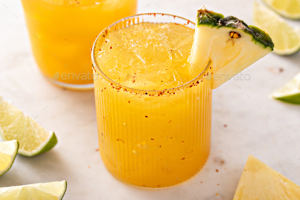 Pineapple margarita cocktail in glasses with tajin rim Stock Photo by ...