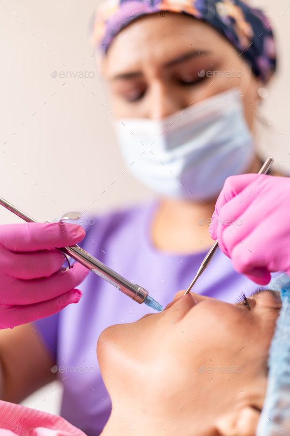 Dentist giving anesthesia injection to patient Stock Photo by GSR ...