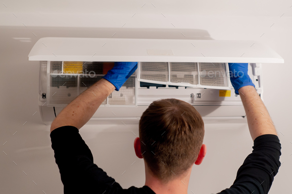 close up in the apartment the cleaner is cleaning the filters in air ...